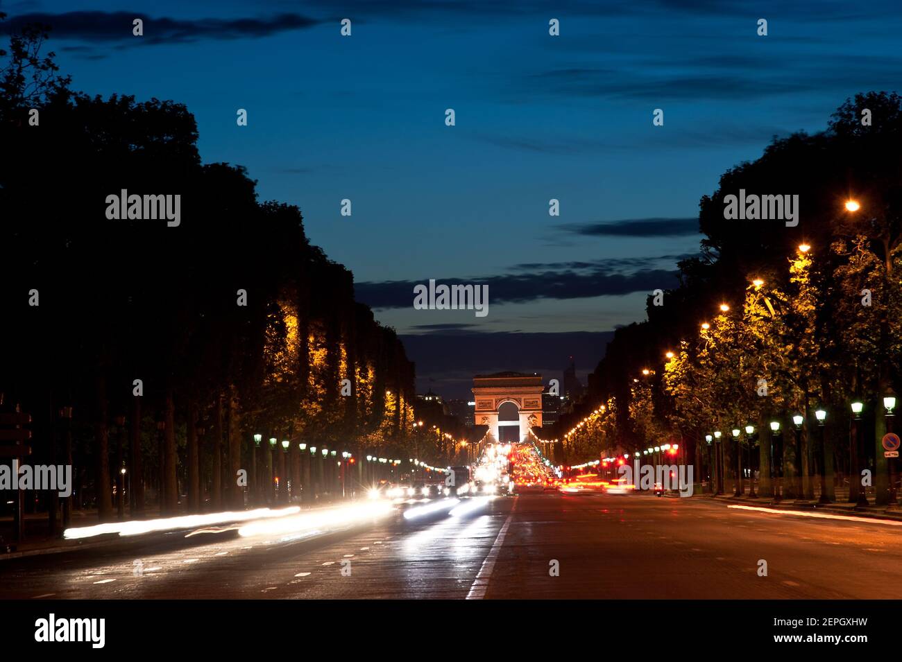 Champs-Elysees avenue at night with the Triumphal Arch in the ...