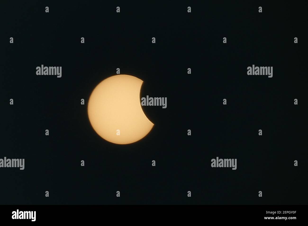 A view of the partial solar eclipse. Part of the sun is being covered ...