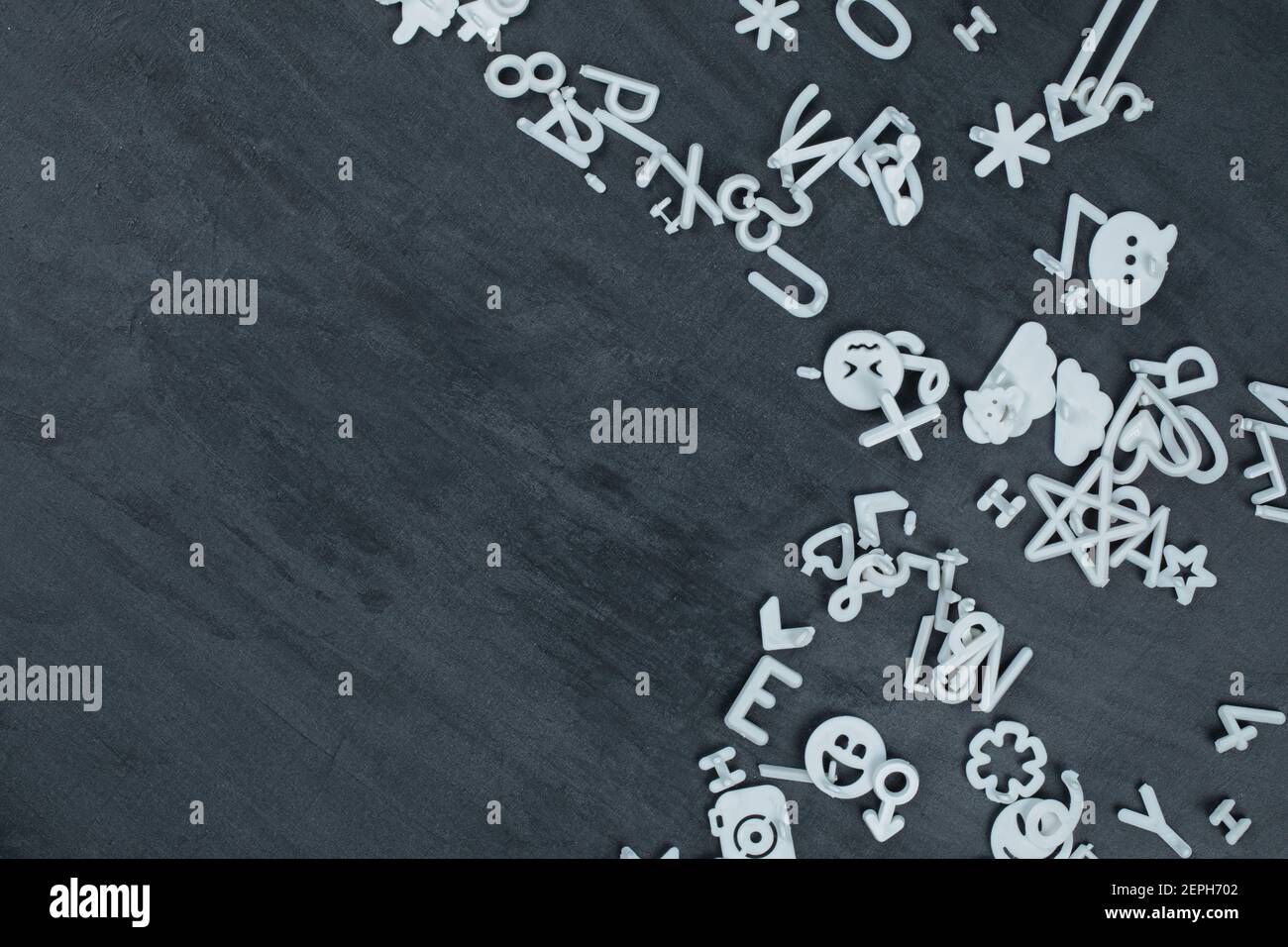White plastic letters, icons and symbols on grey background Stock Photo ...