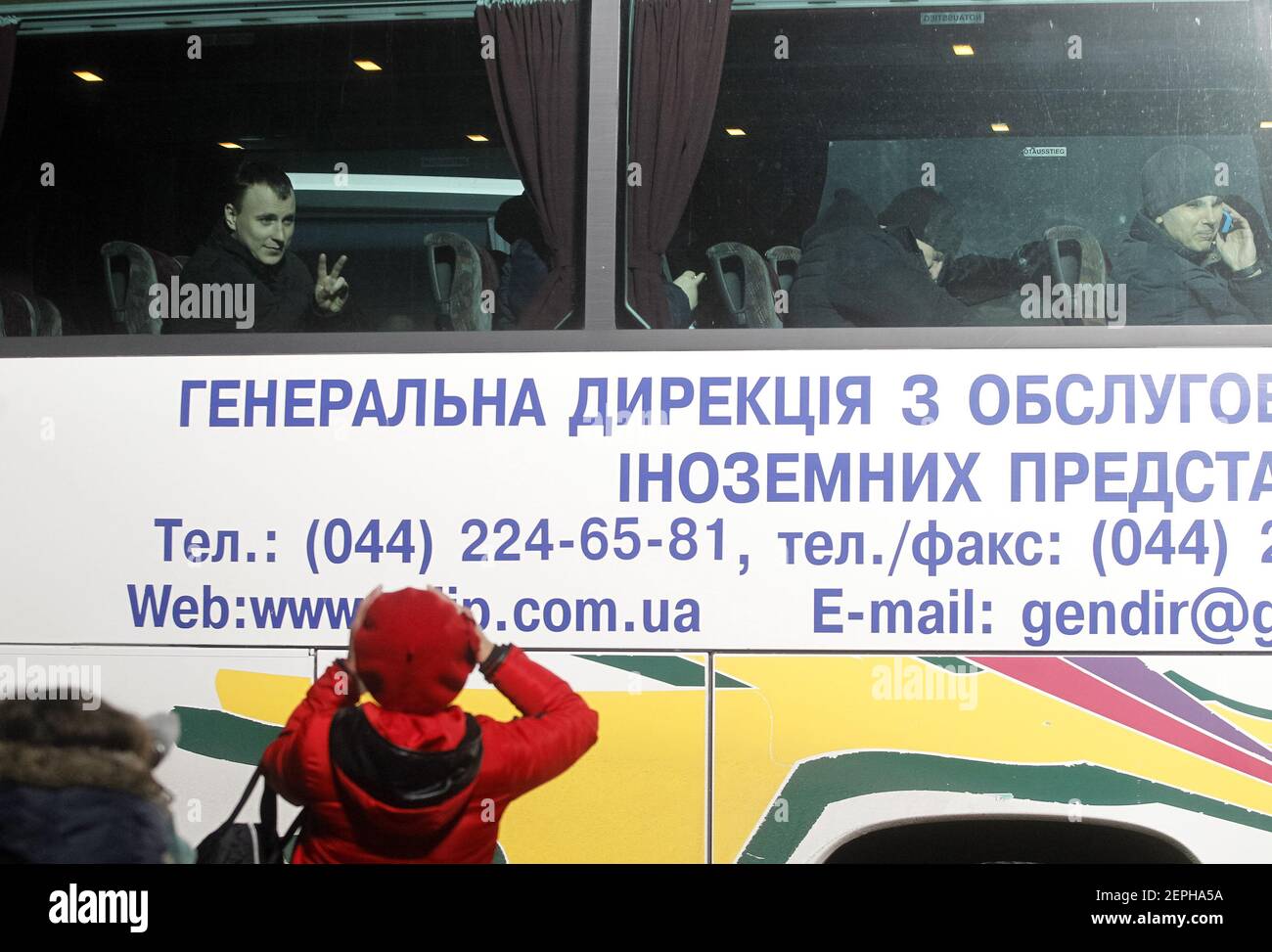 Former Ukrainian prisoners sit in a bus after arriving at the ...