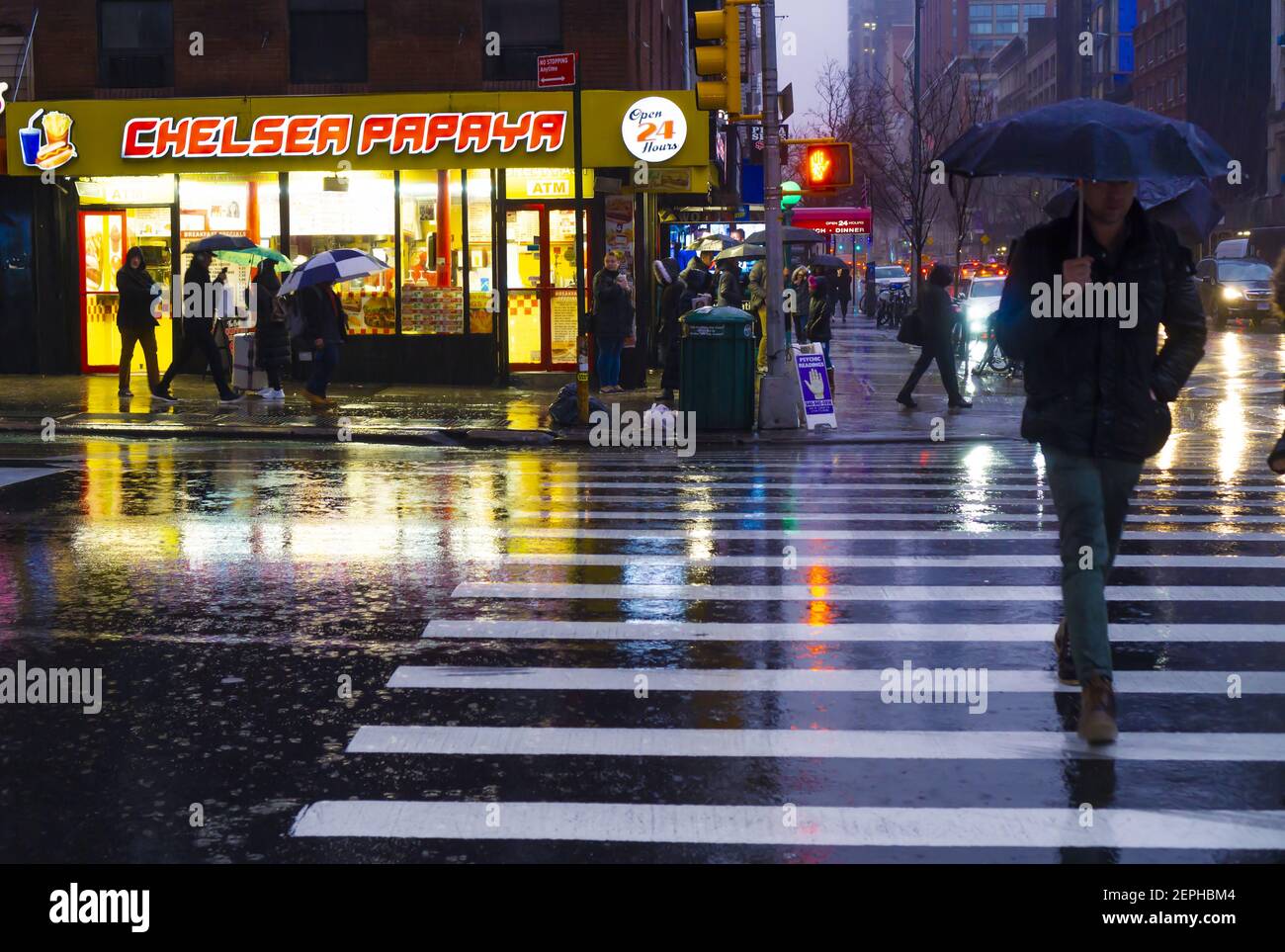 Pedestrians trudge through the rain in the Chelsea neighborhood of New ...