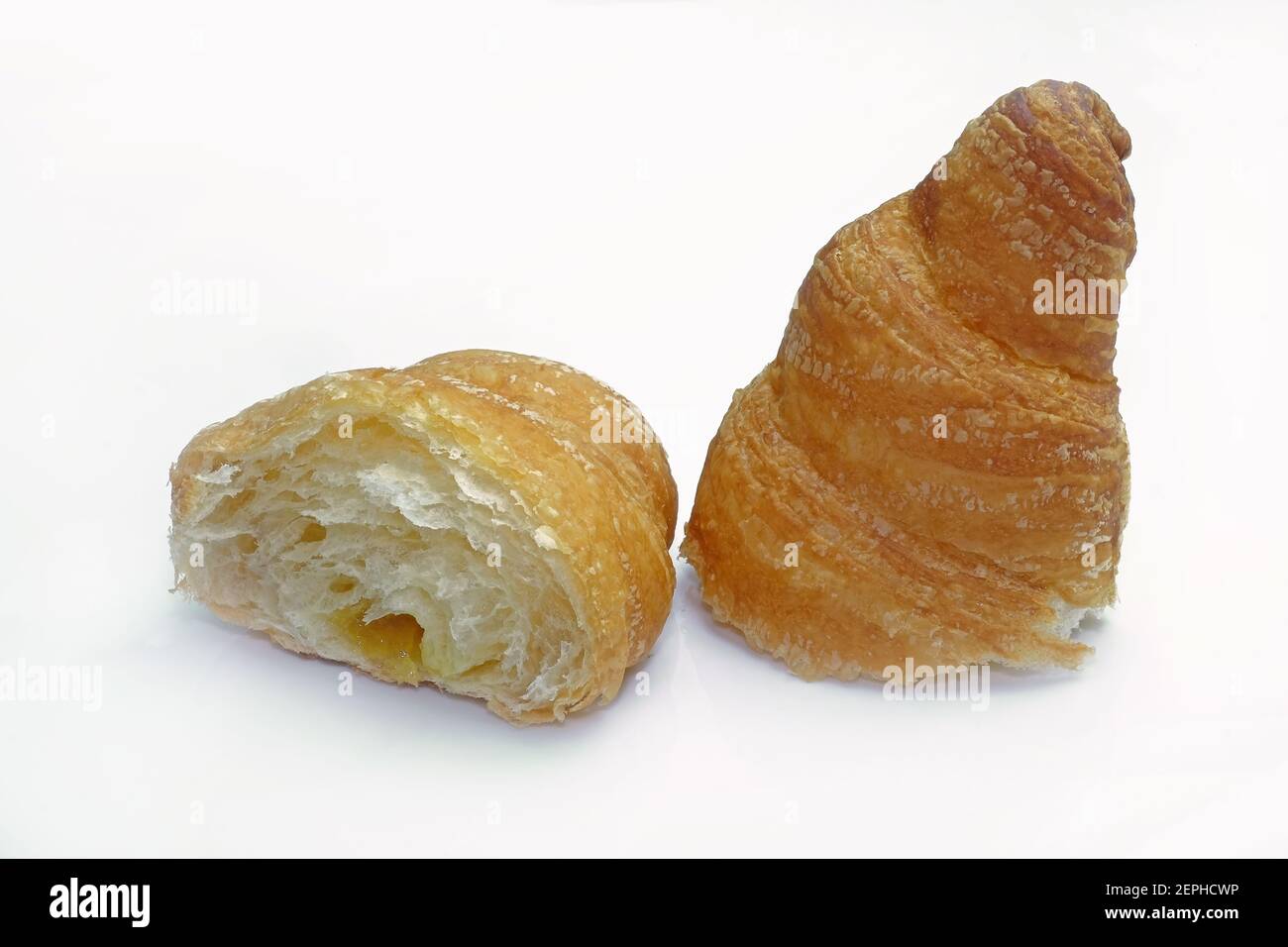 Half croissant on a white background. A bitten croissant with a filling ...