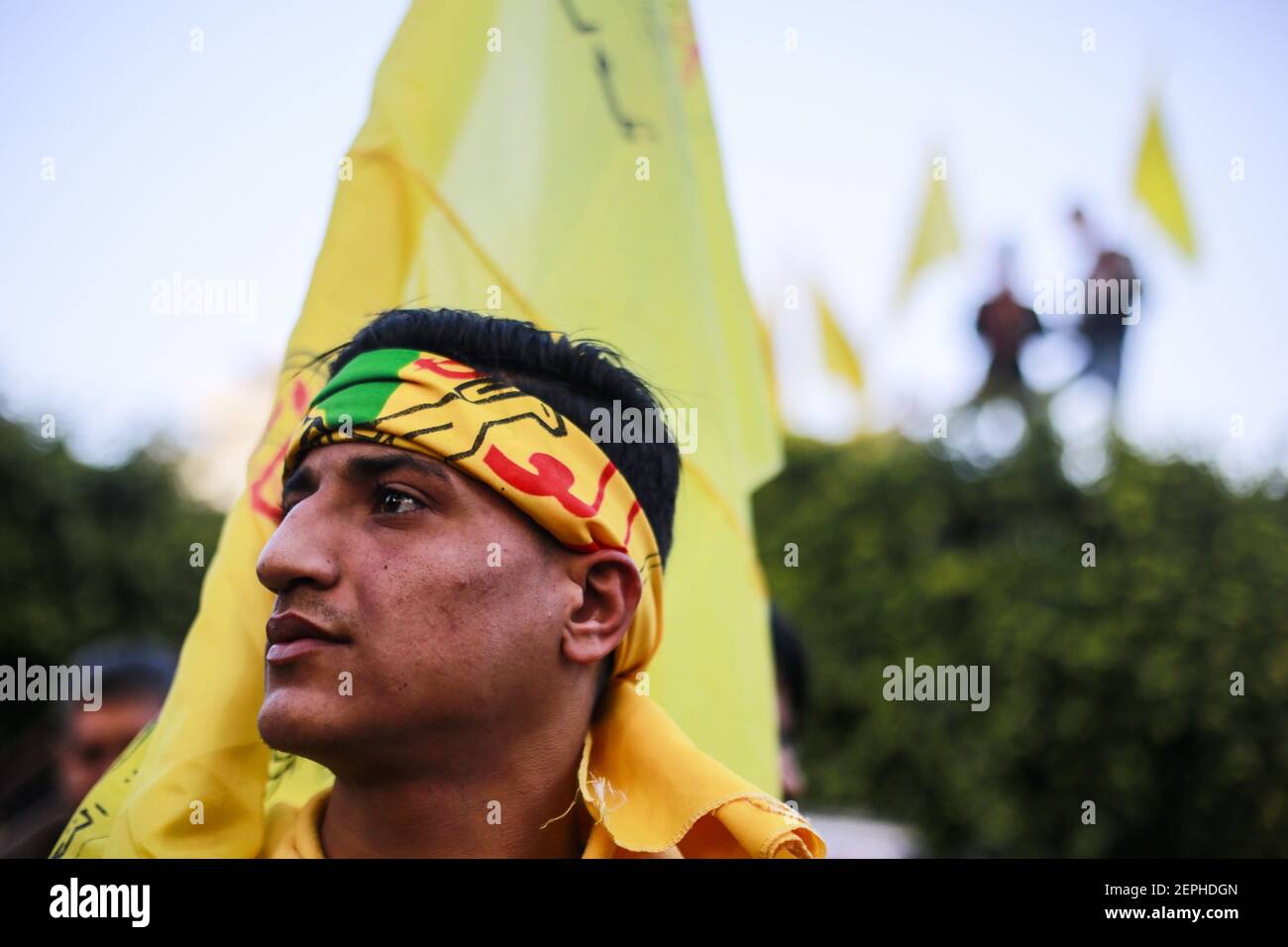 A Palestinian supporter of the Fatah movement holds a flag during a ...