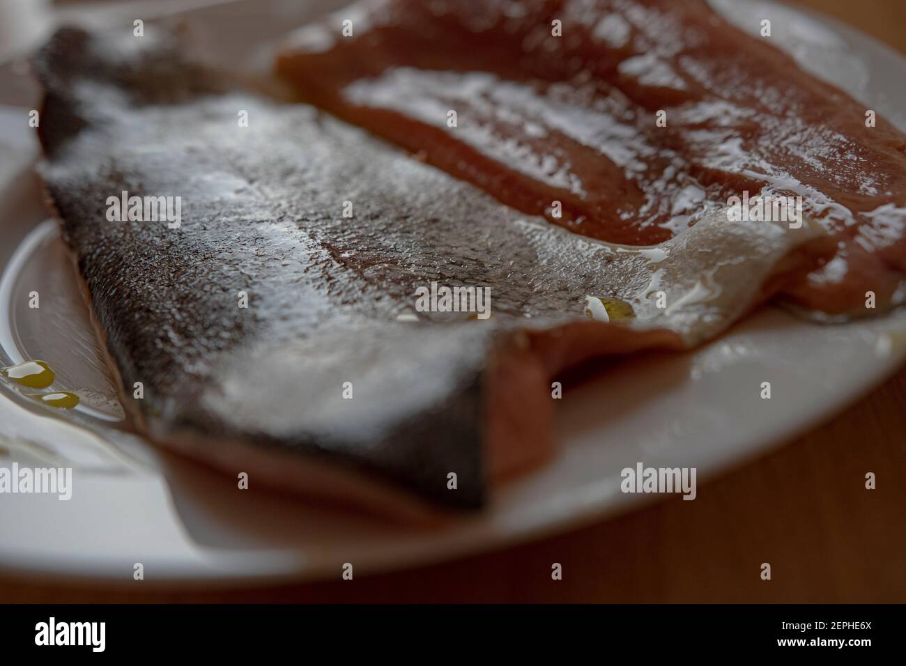 Woman cooking trout Stock Photo - Alamy