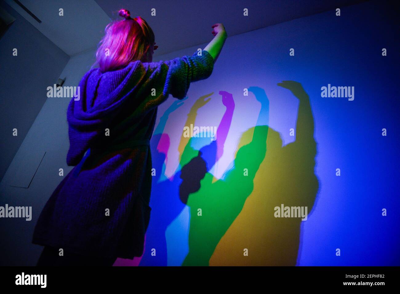 A visitor interacts with an RGB illusion at the Museum of illusions in ...