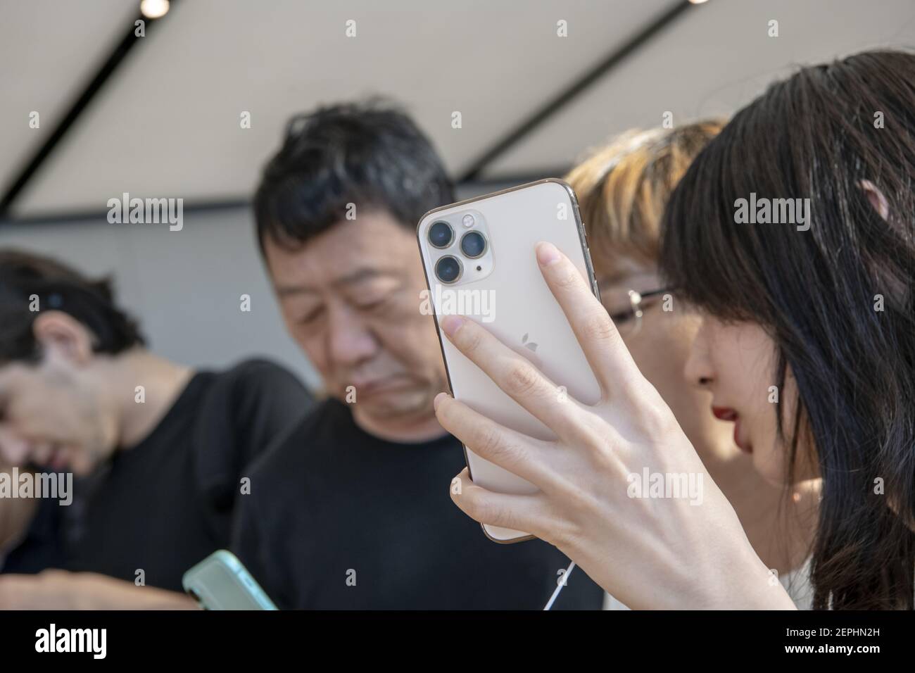In this unlocated photo, customers crowd to an Apple store and ...