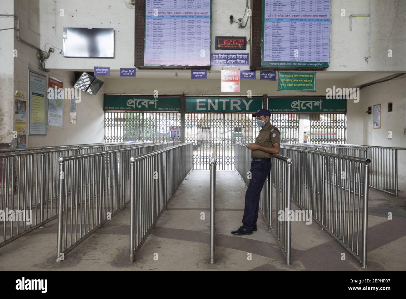 A railway security passing idle time inside Kamlapur railway station as ...