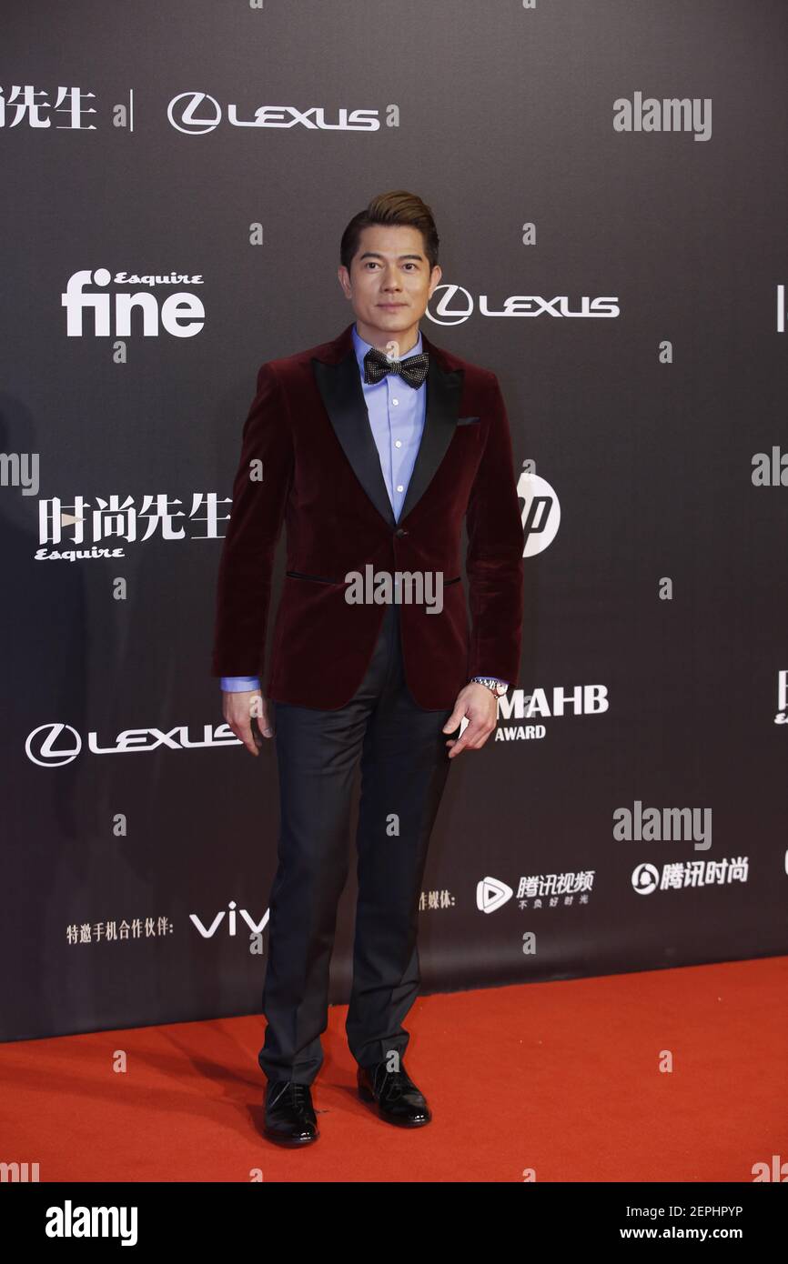 --FILE--Hong Kong singer, dancer and actor Aaron Kwok Fu-shing poses in red suit to take ...