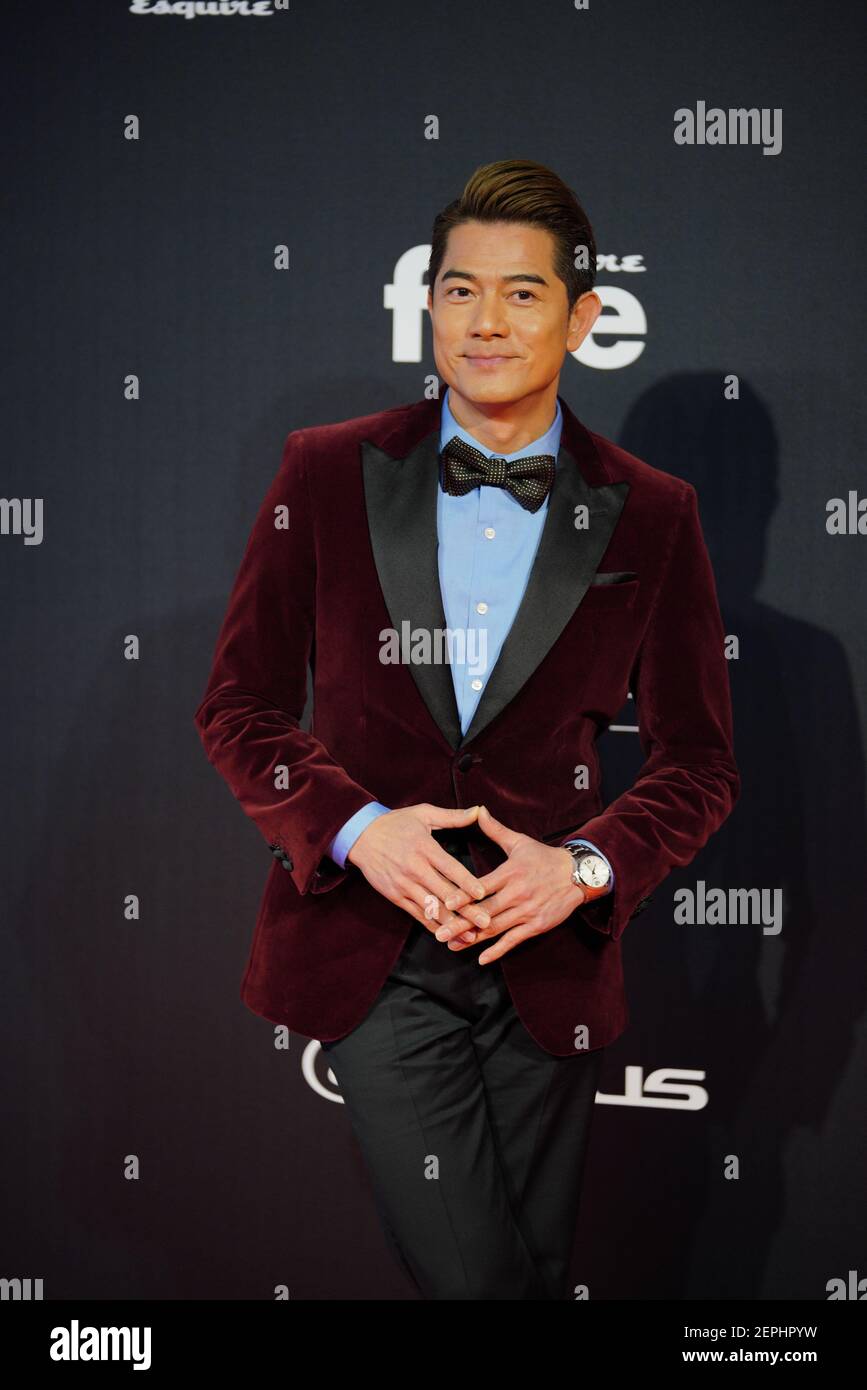 --FILE--Hong Kong singer, dancer and actor Aaron Kwok Fu-shing poses in red suit to take ...