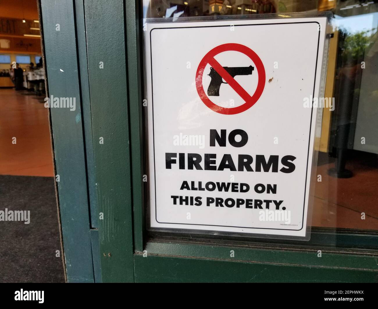Sign with text reading No Firearms Allowed on this Property, with a ...