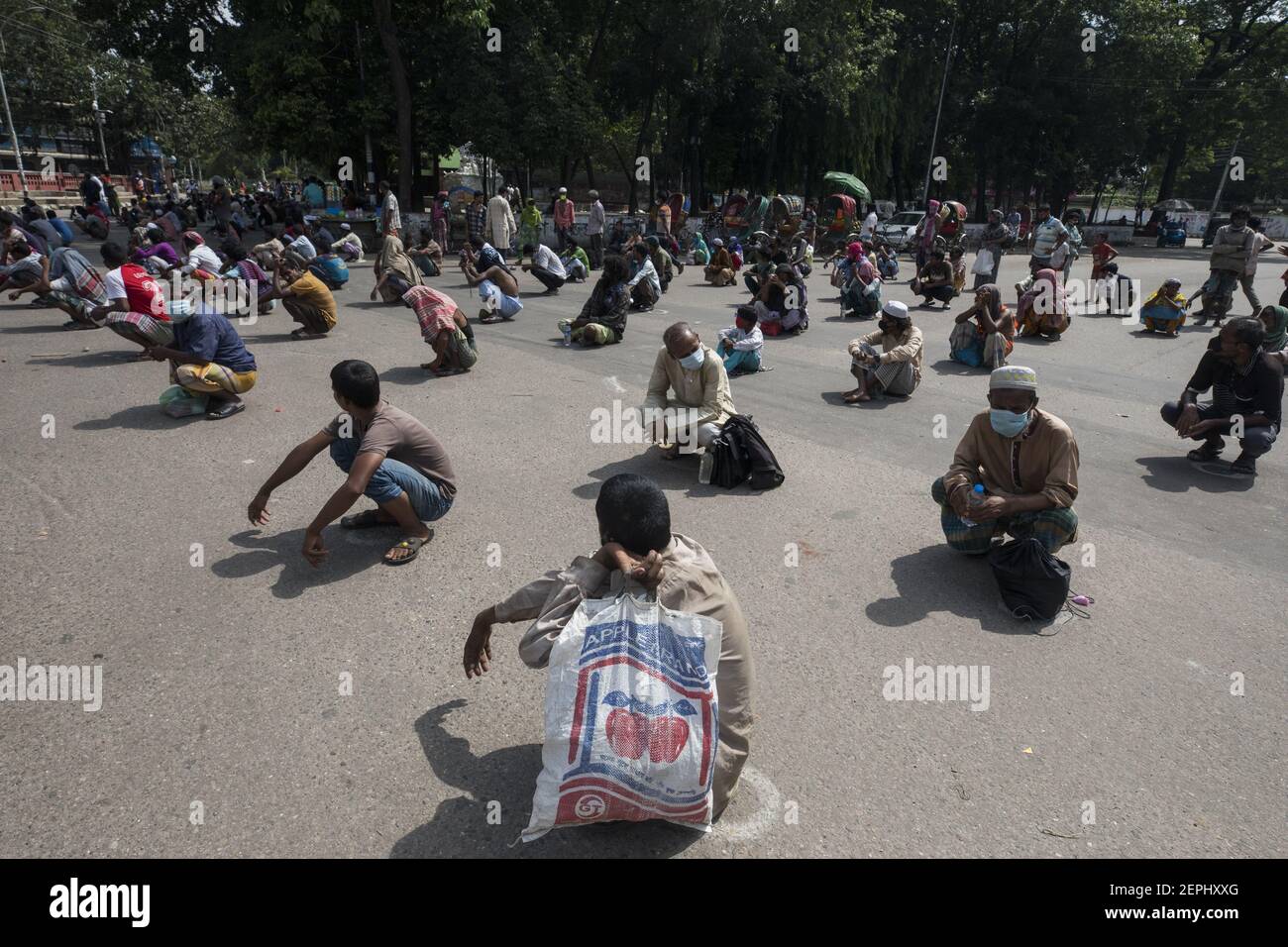 An underprivileged people waits for the food to distribute during ...