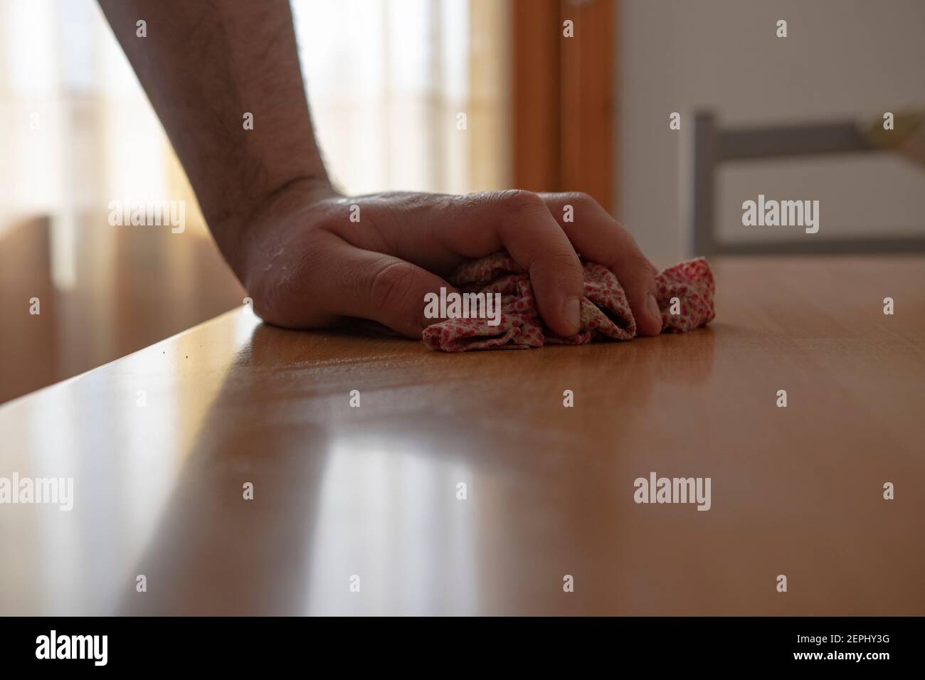 Masculine hand cleaning table Stock Photo - Alamy