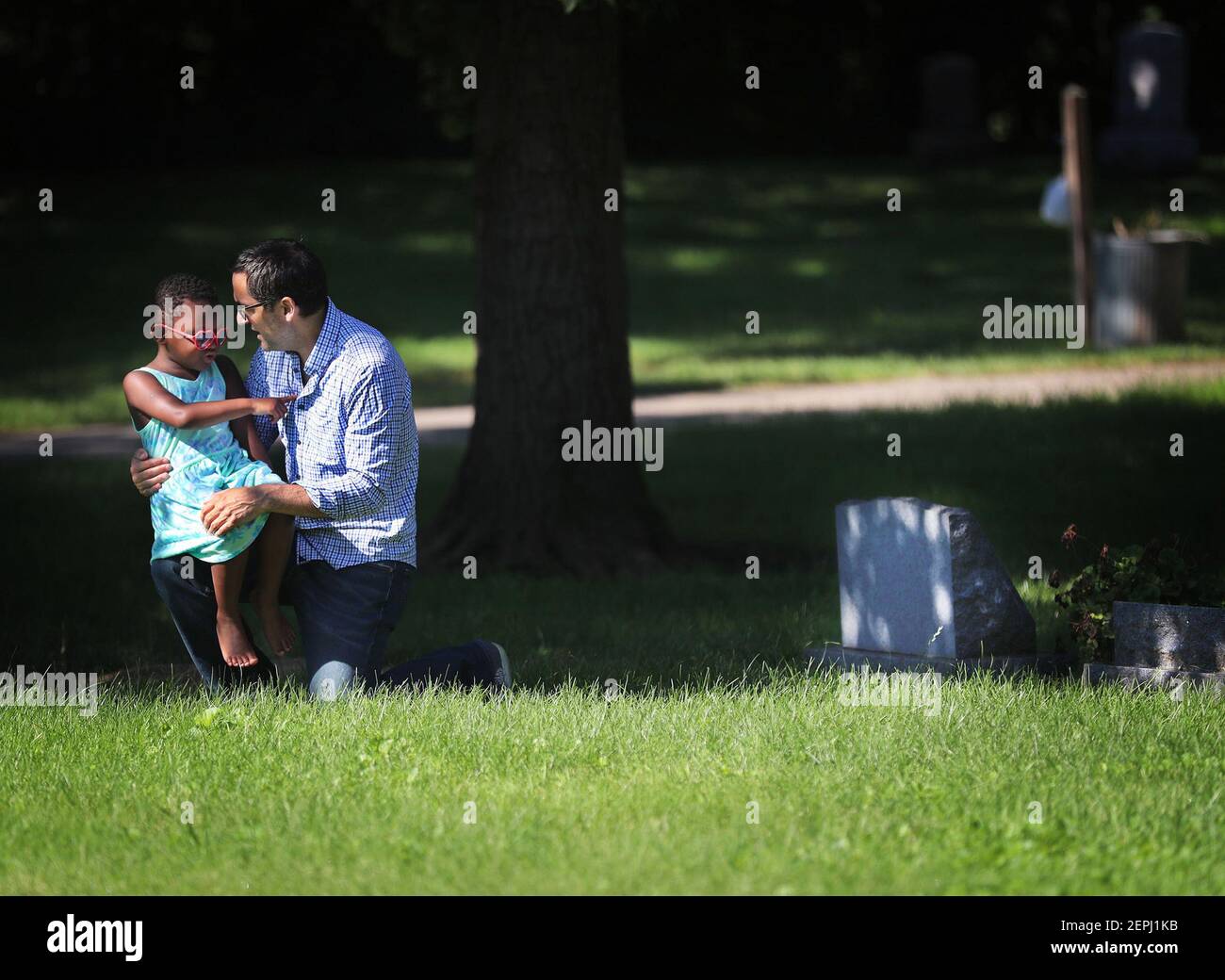 During a visit to Emily Hofher's grave site, Hofher's husband Rob Raub ...