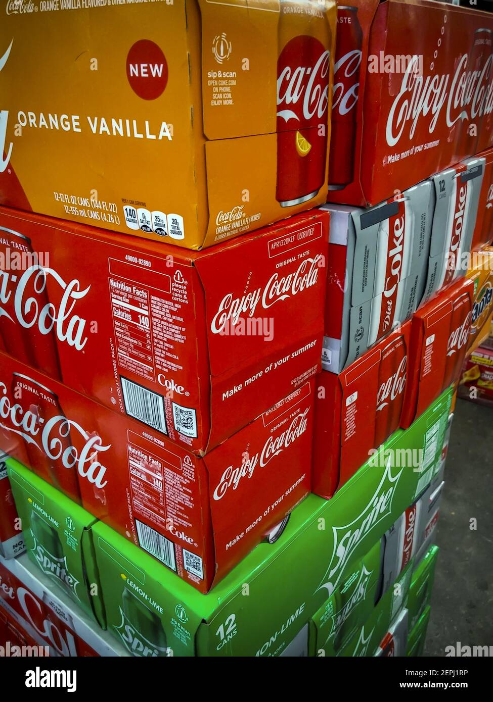 Cases of various flavors of Coca-Cola and Coke brands in a supermarket ...