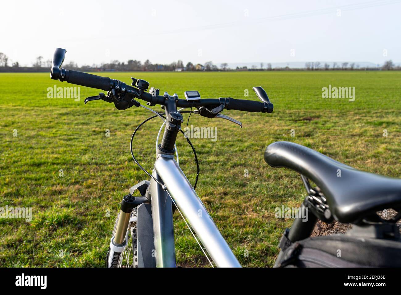 A bicycle handlebar seen from the first person perspective. Visible ...