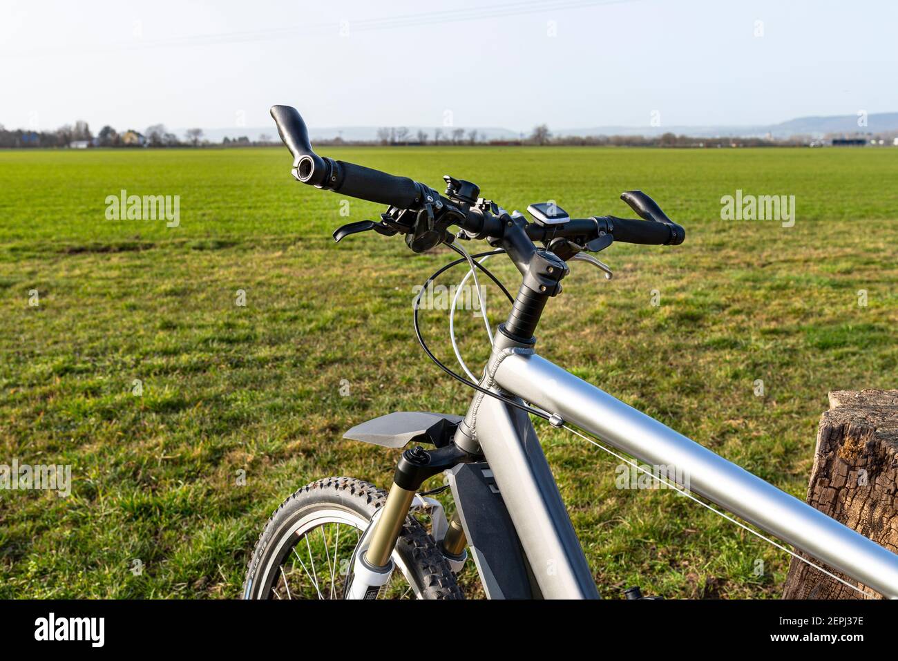 A bicycle handlebar seen from the first person perspective. Visible ...