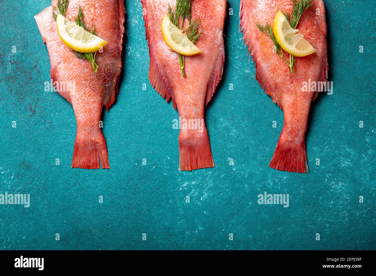 Fresh red sea bass on blue background Stock Photo - Alamy