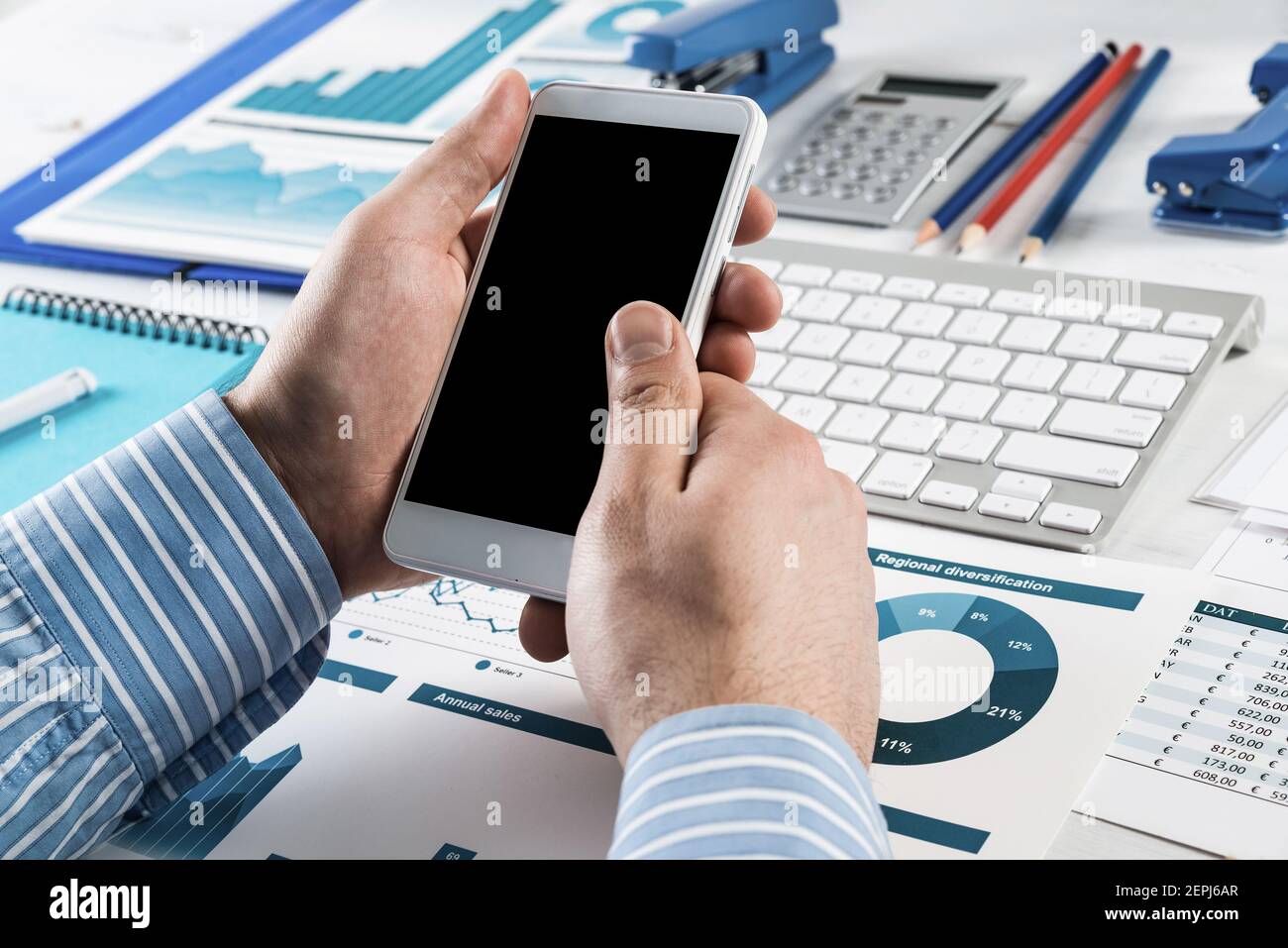 businessman with a smartphone, works in the office Stock Photo - Alamy