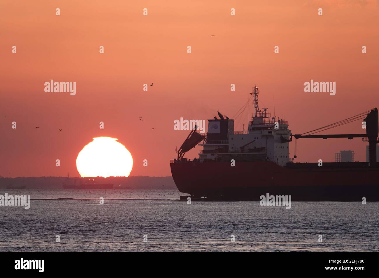 Freighter at sunset hi-res stock photography and images - Alamy