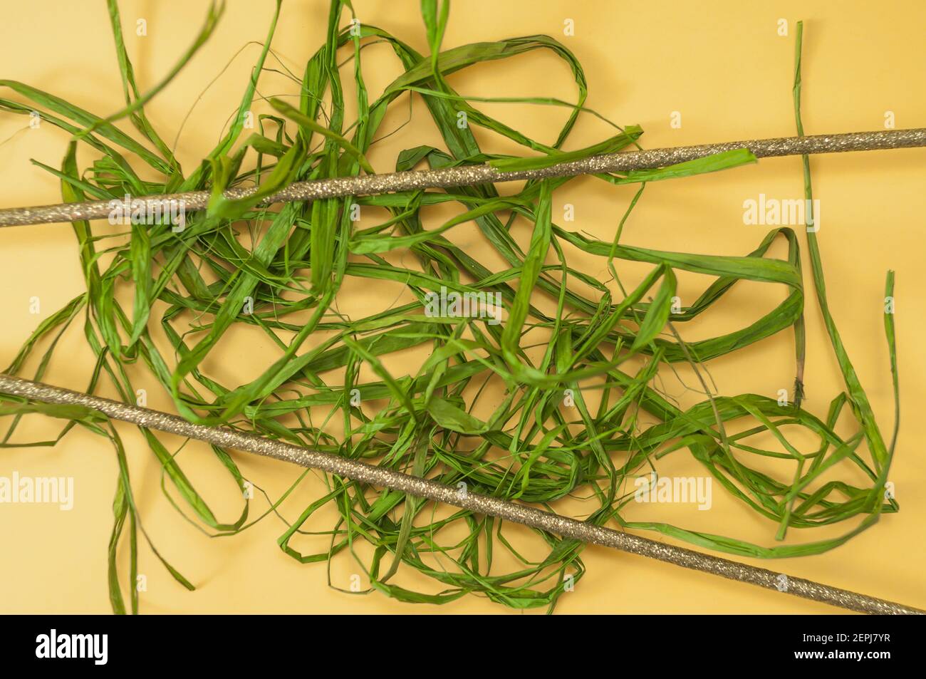 Beautiful background. Green bast lies on a yellow background. There are ...