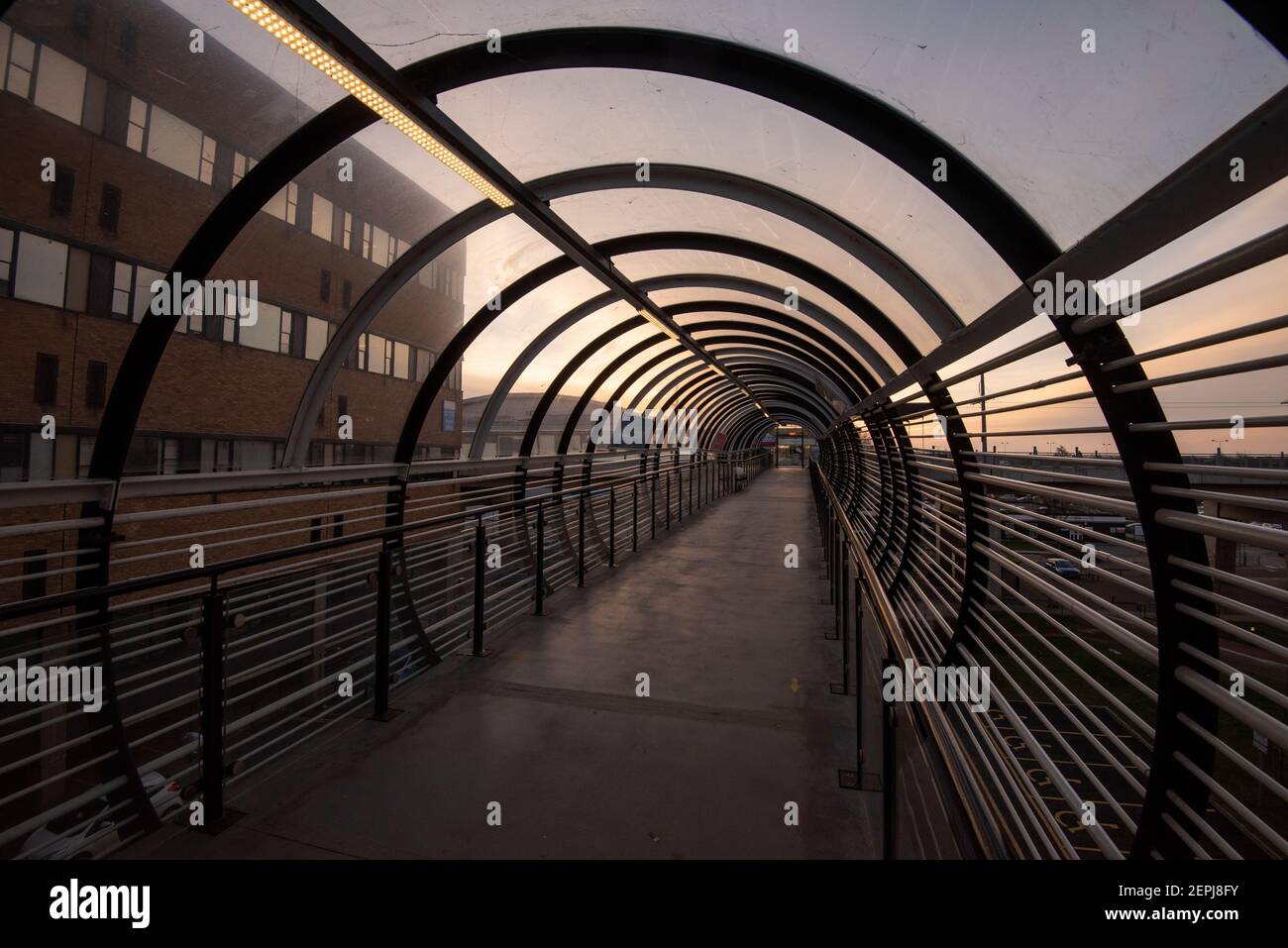 Morning light on the Sir Peter Mansfield tram bridge at the Queens ...
