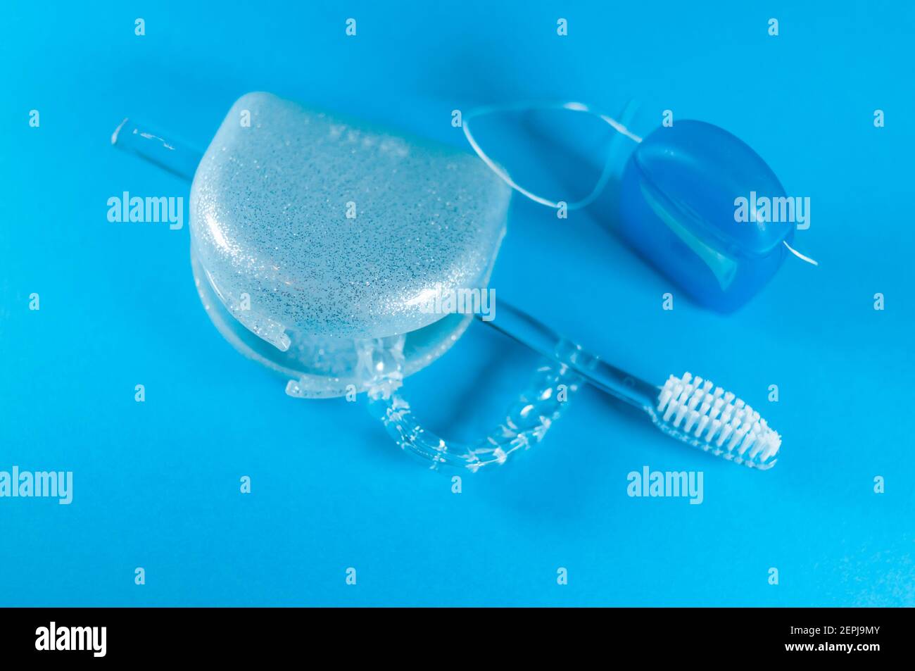 a dental splint lies in an open storage box. there is a toothbrush and ...
