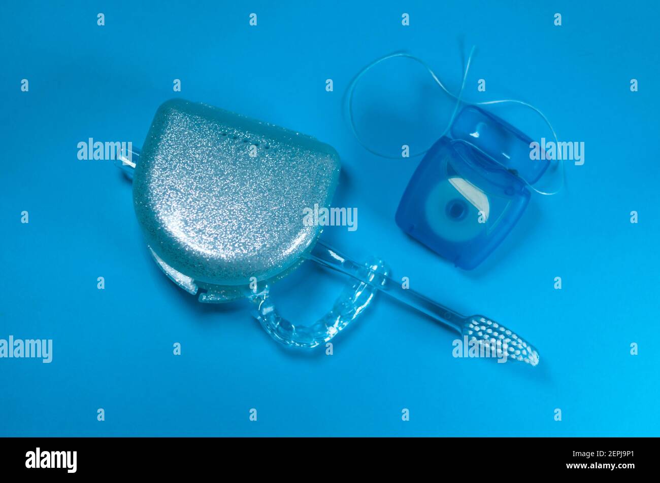 a dental splint lies in an open storage box. there is a toothbrush and ...