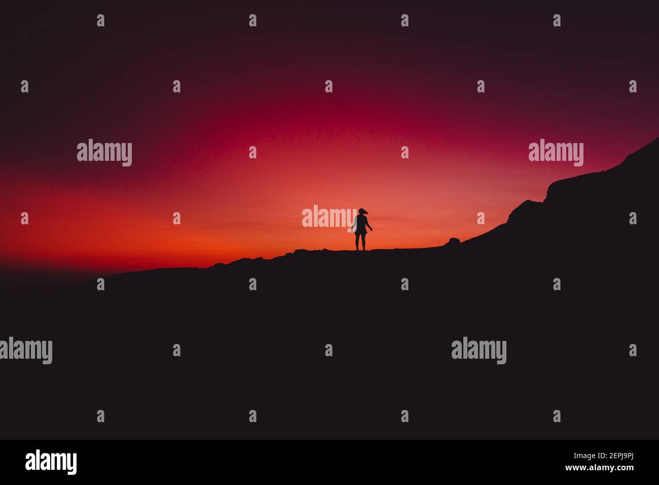 Bright sunset or sunrise and alone silhouette of people Stock Photo - Alamy