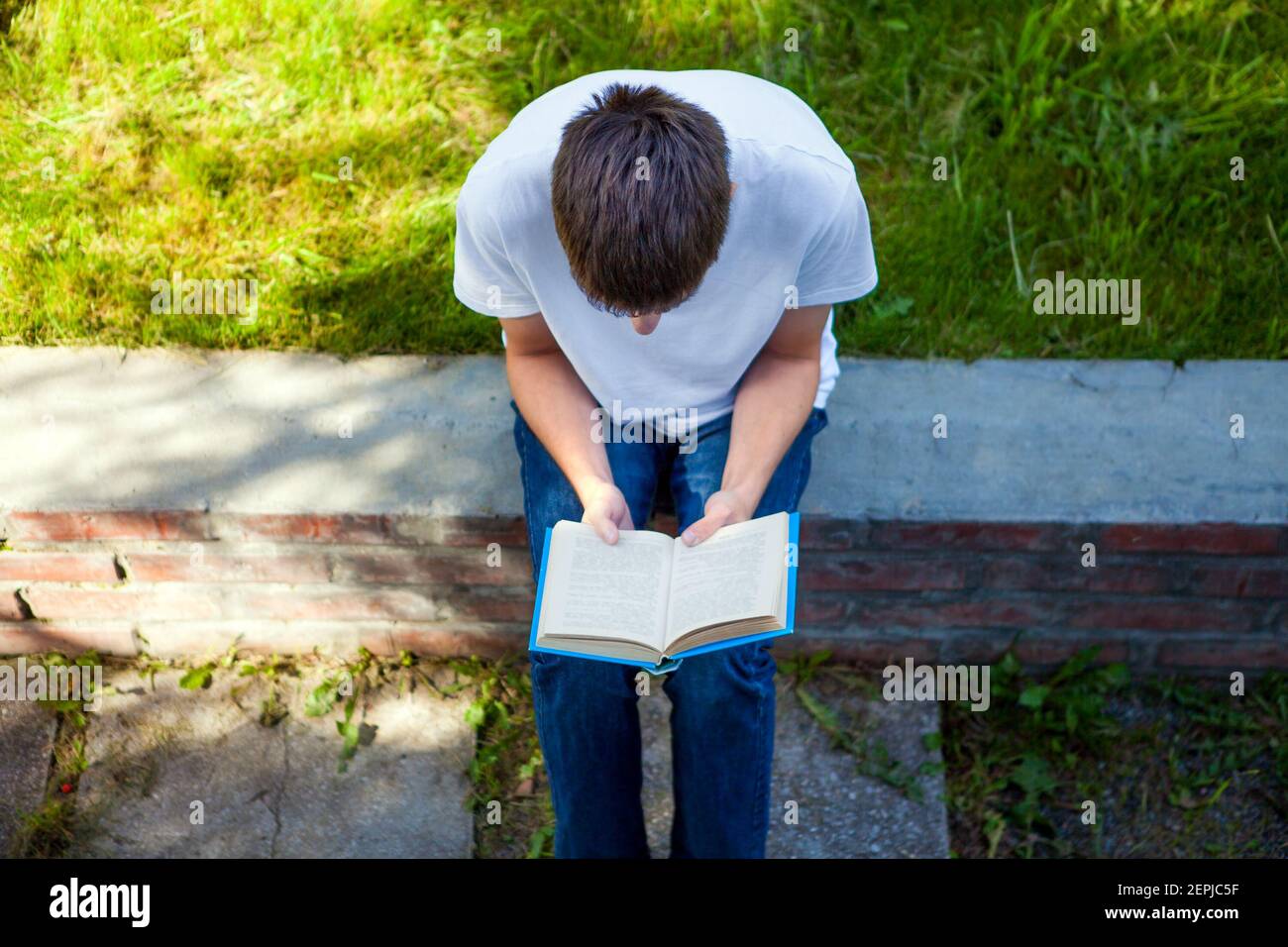 Young guy opened book hi-res stock photography and images - Alamy