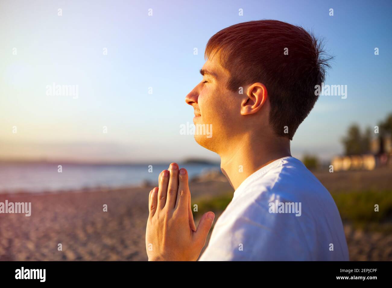 Young man praying hi-res stock photography and images - Alamy