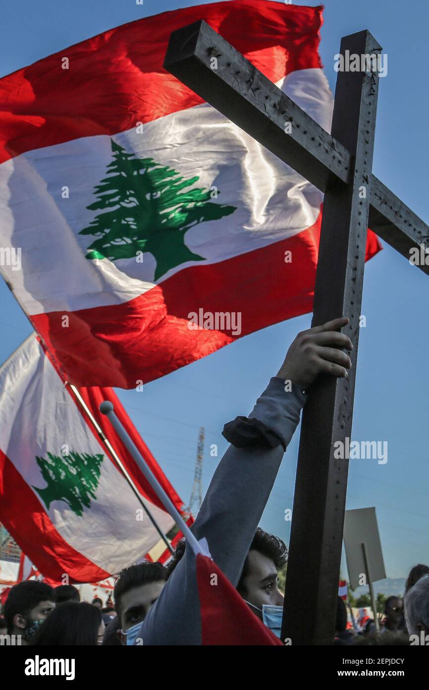 Bkerki, Lebanon. 27th Feb, 2021. Anti-government activists wave flags ...