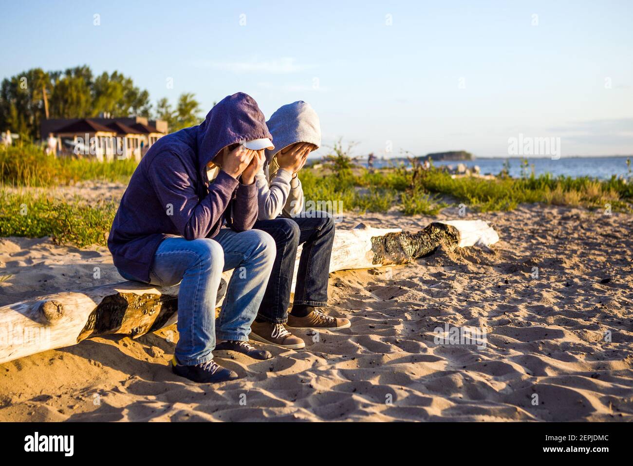 Two Sad Men sit on the Log at the Seaside Stock Photo - Alamy