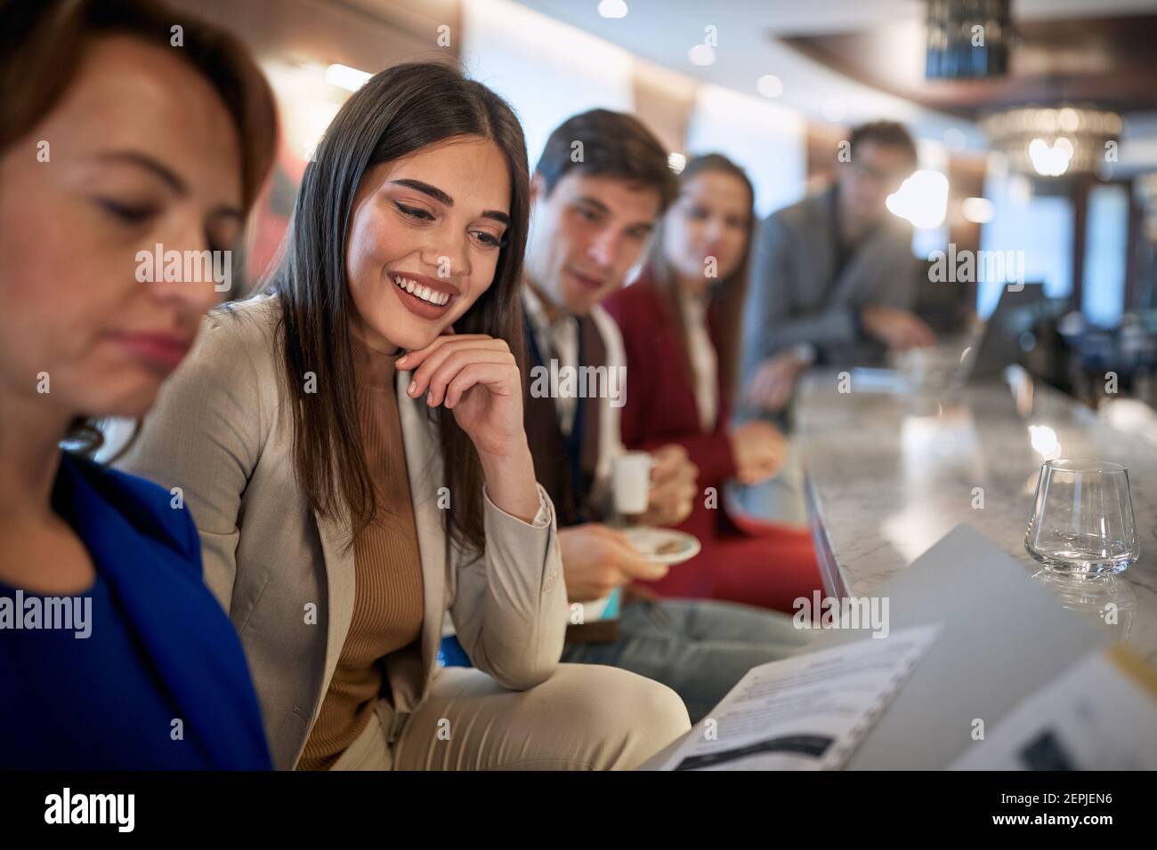 Business people at coffee break in a cheerful atmosphere at the bar ...