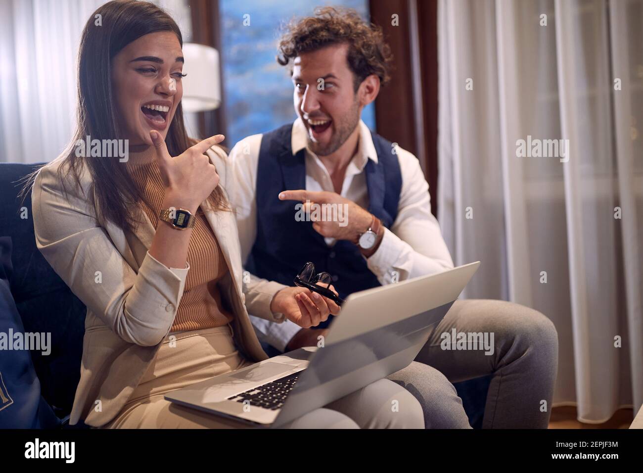 Young colleagues having fun in a pleasant atmosphere at the hotel lobby ...