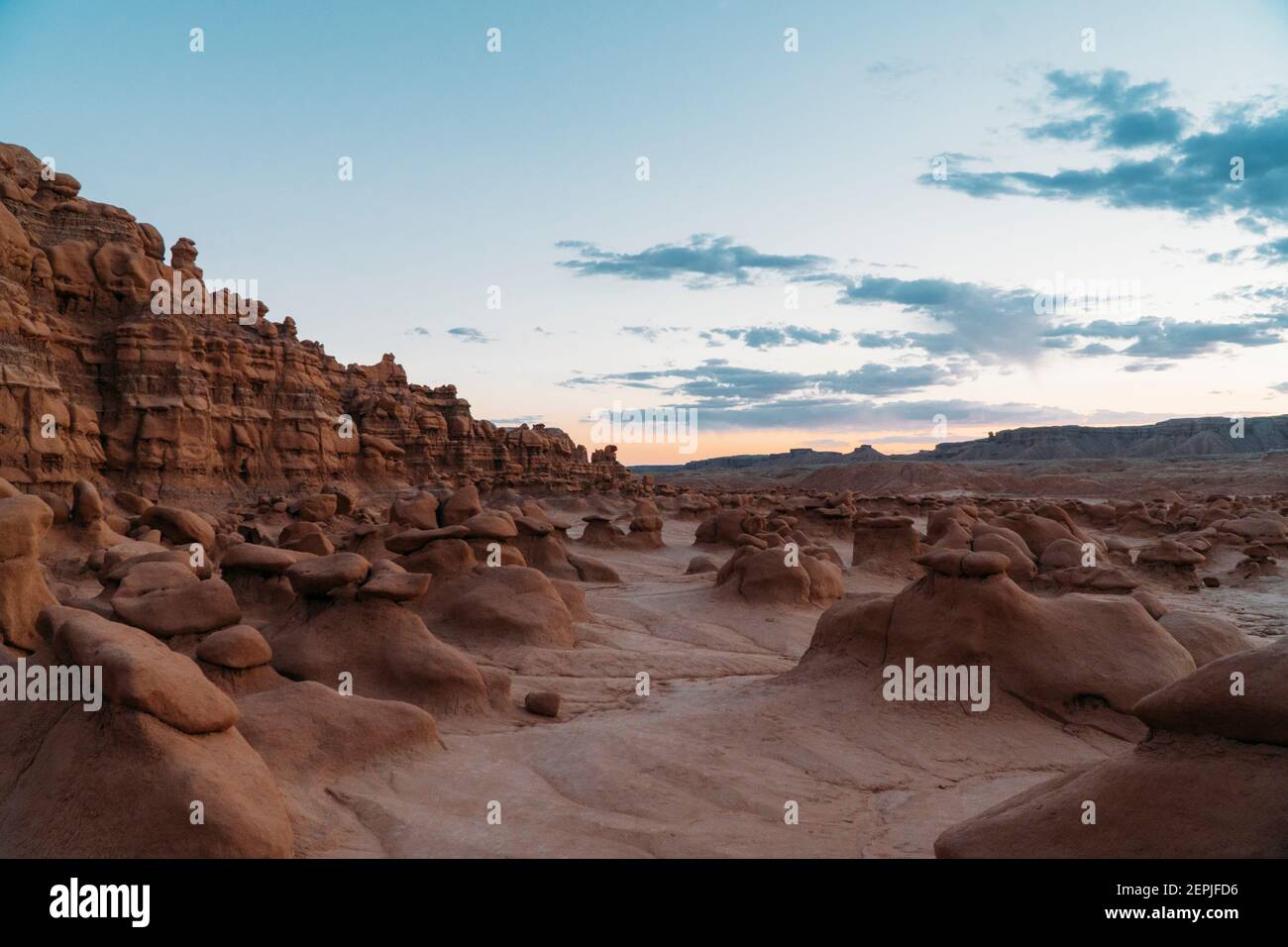 Red mushroom rocks in Goblin Valley state park during sunrise with ...