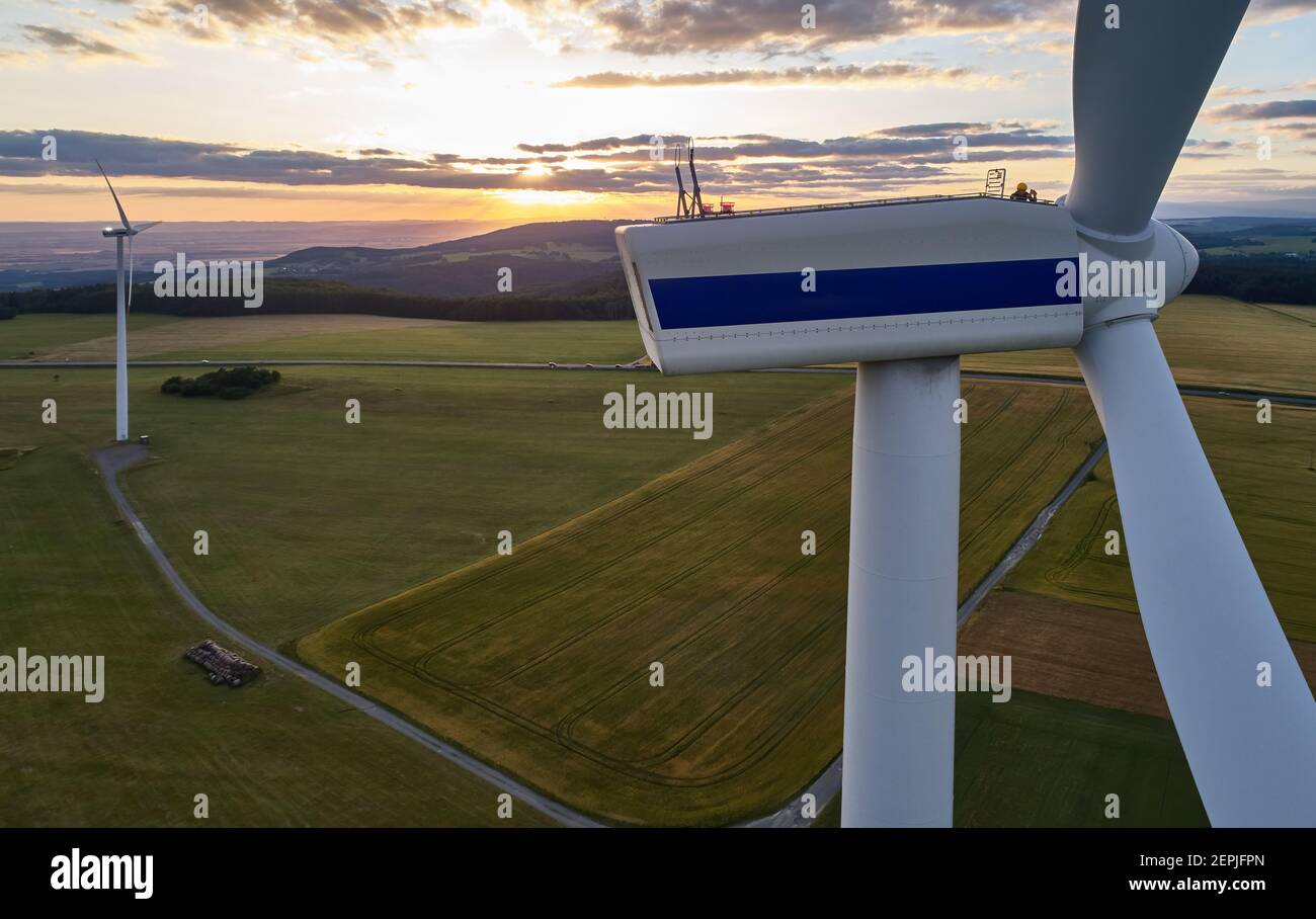 Aerial view of wind turbine farm. Wind power plants in green landscape ...