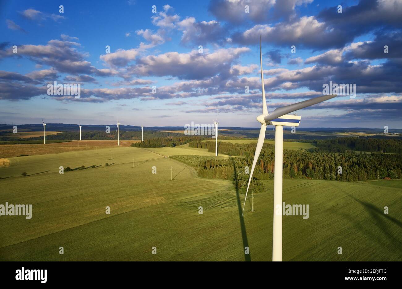 Aerial view of wind turbine farm. Wind power plants in green landscape ...