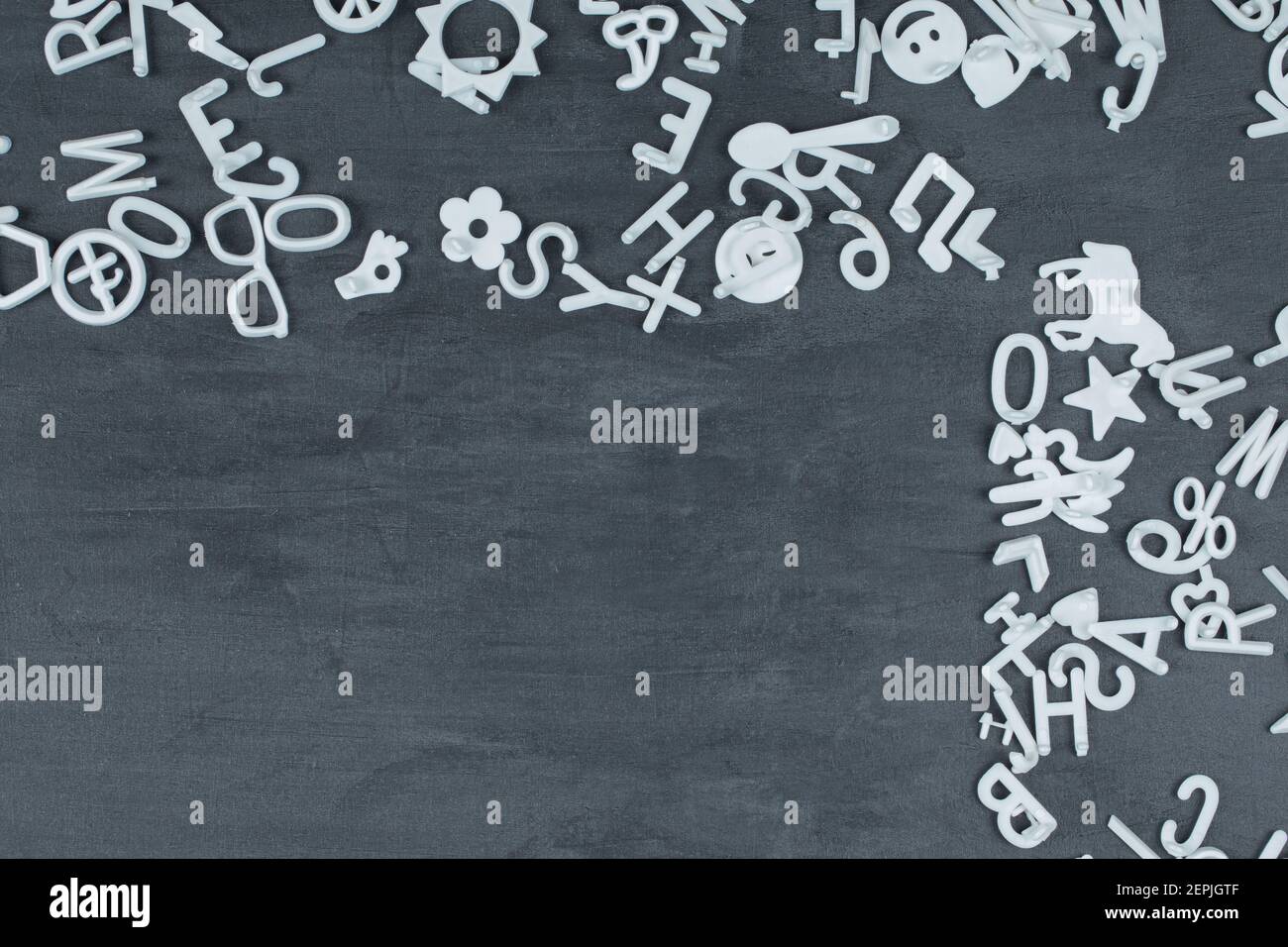 White plastic letters and icons on black background Stock Photo - Alamy