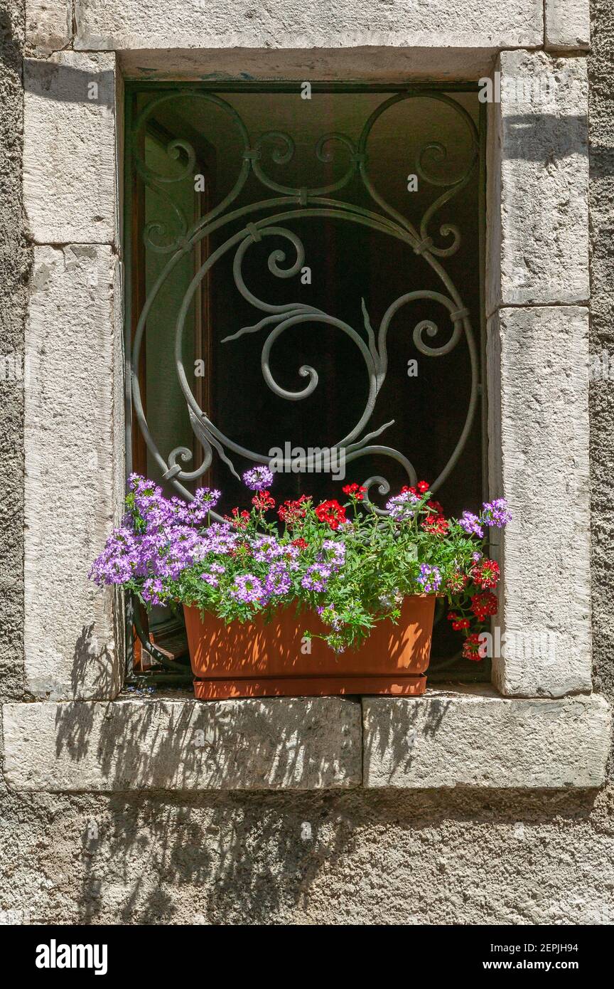 stone window with planter and iron decoration Stock Photo - Alamy