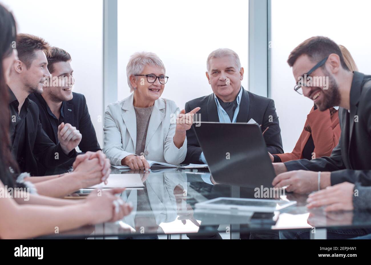 Team gathering around glass table hi-res stock photography and images ...
