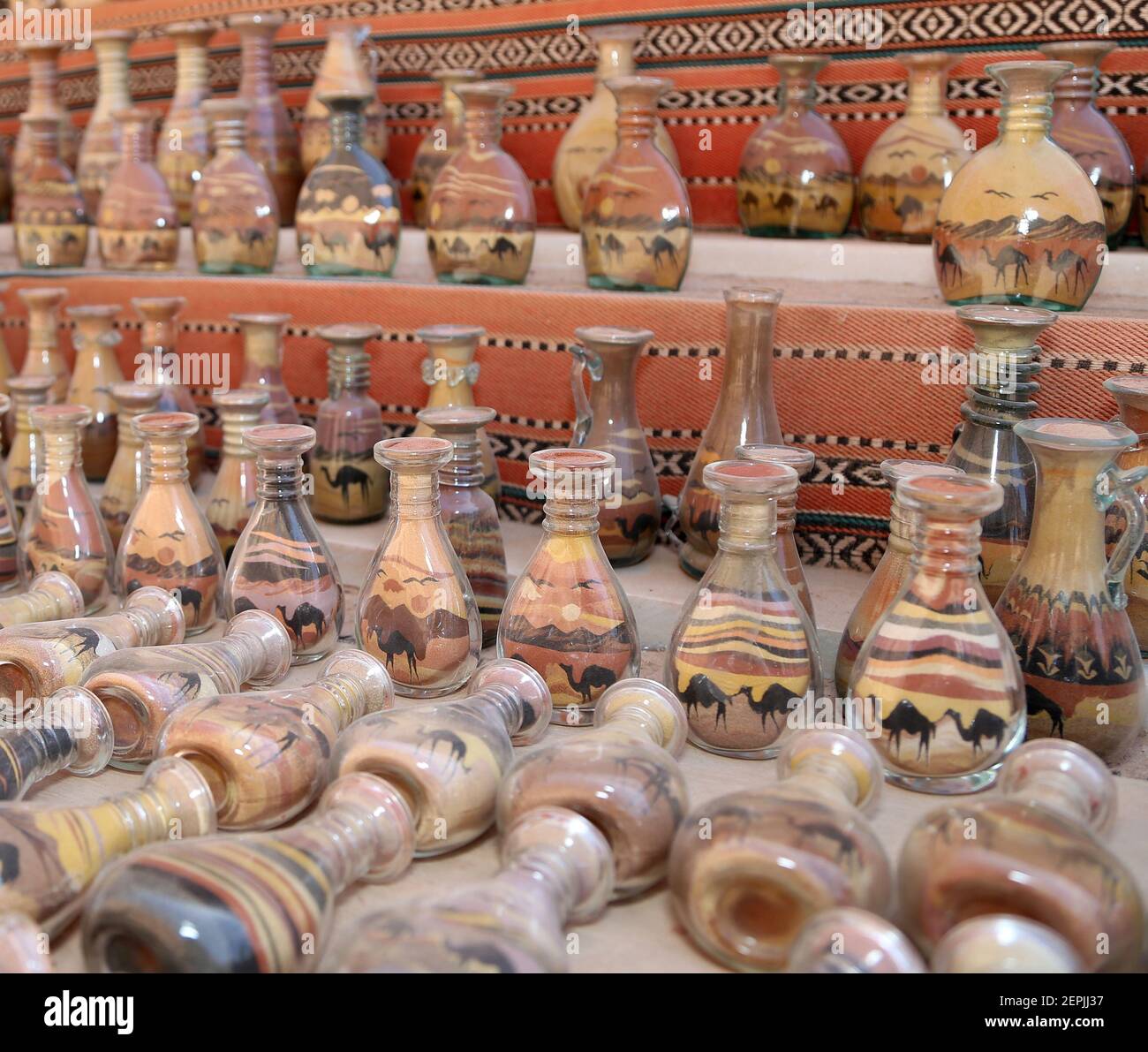 traditional local souvenirs in Jordan- bottles with sand and shapes of ...
