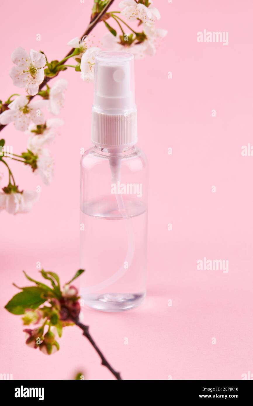 bottle with transparent liquid. alcohol hand sanitizer over pink ...