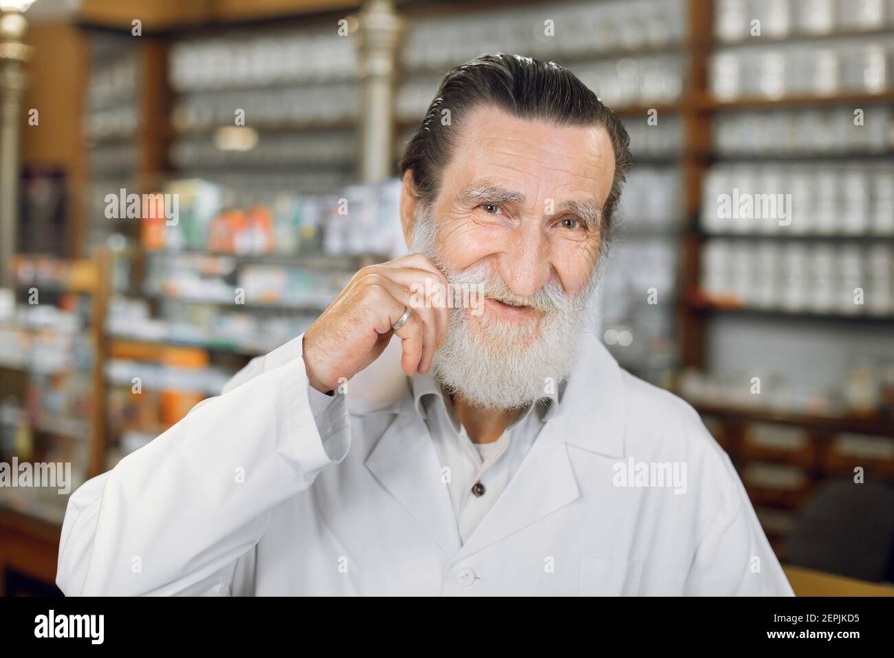 Happy pharmacist. Close up portrait of smiling handsome senior ...