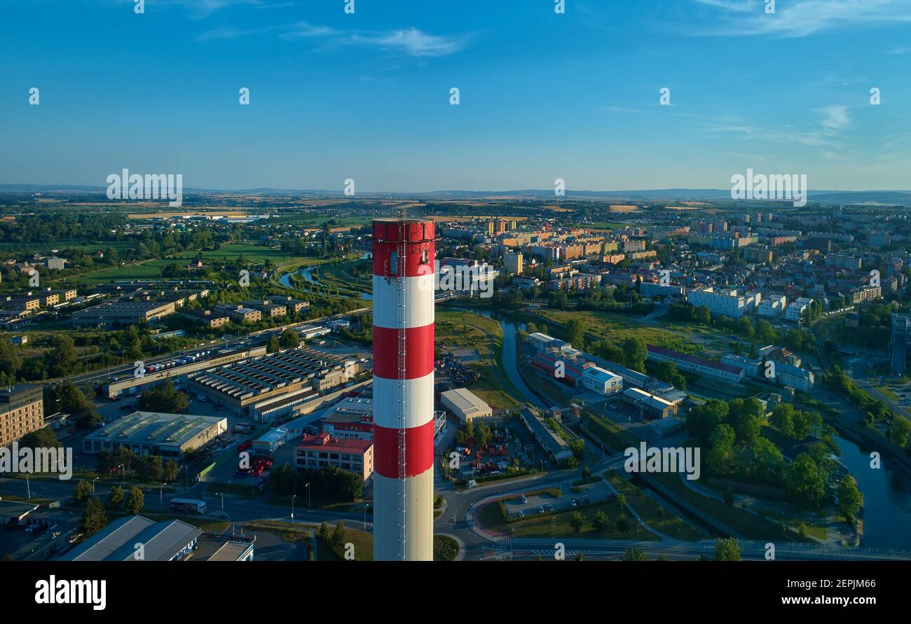 Aerial view of tall chimney of thermal power plant, painted white and ...