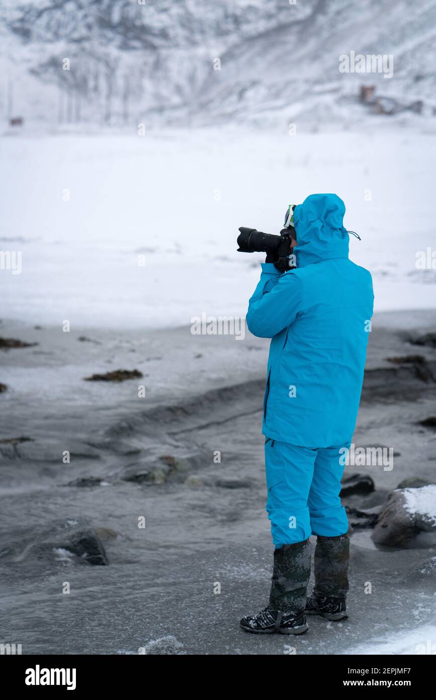 Professional photographer on task in winter wilderness Stock Photo - Alamy