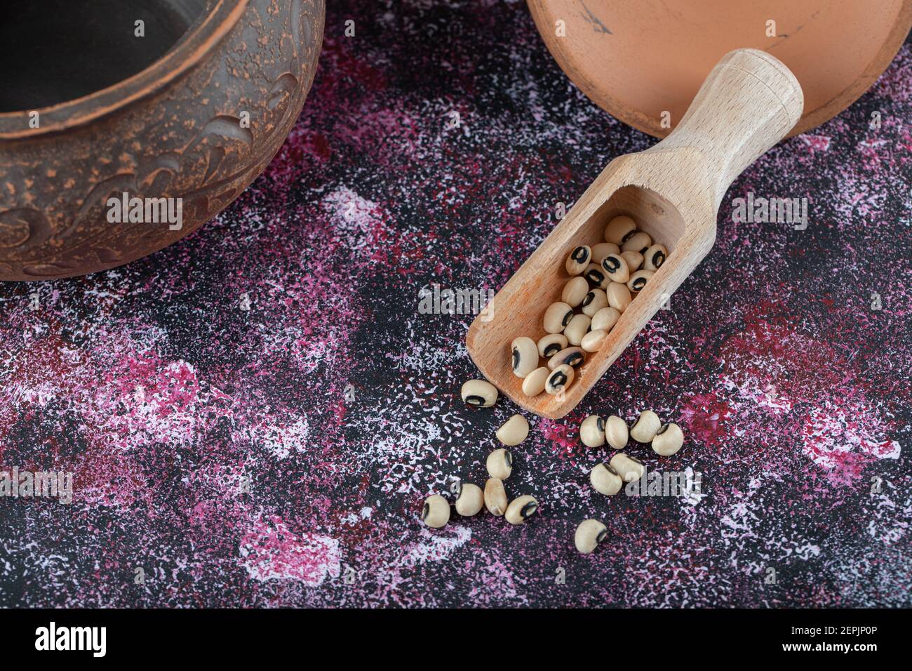 Wooden spoon with beans on a colorful background Stock Photo - Alamy