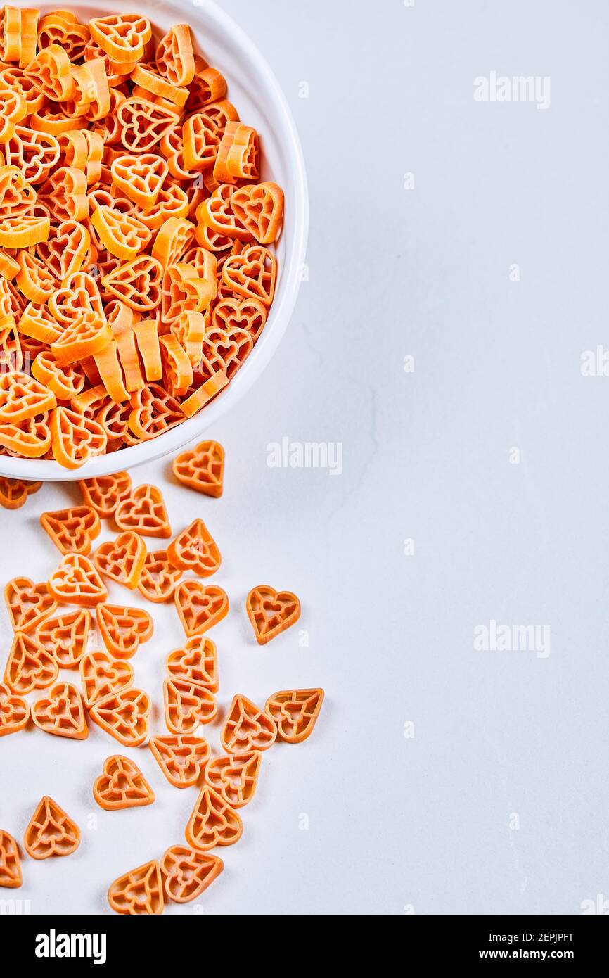 Heart shaped pasta on white bowl Stock Photo - Alamy