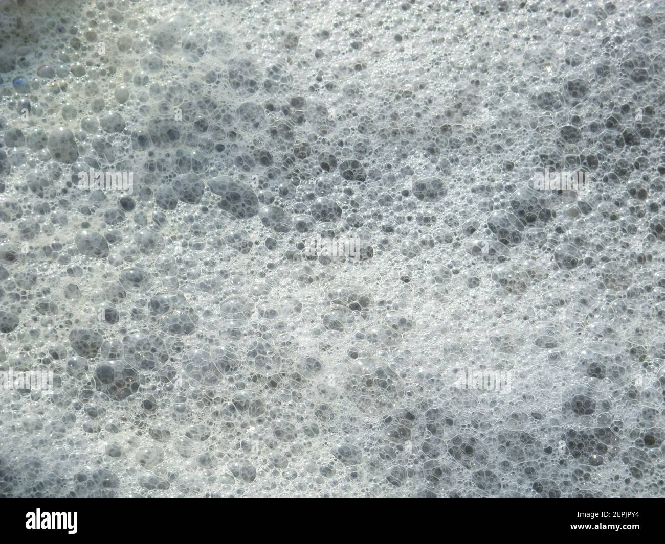 Foam made by the wave on the beach Stock Photo - Alamy