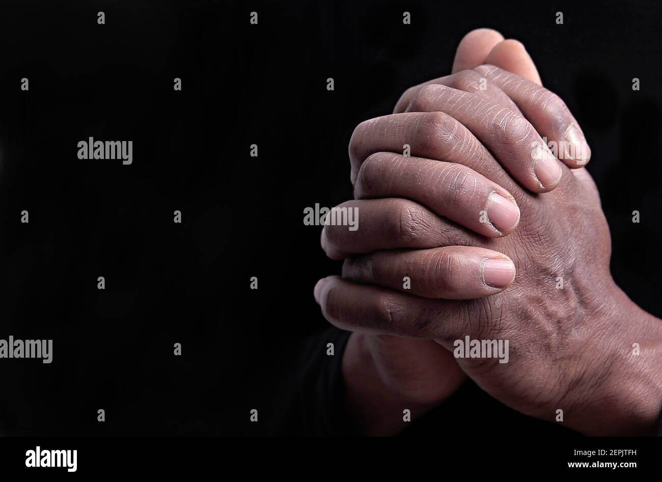 man praying to god with hands together Caribbean man praying with grey ...