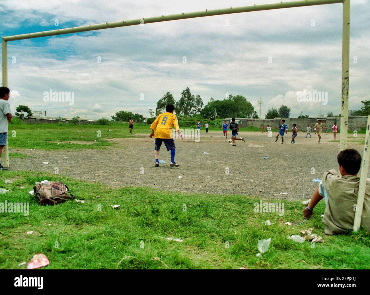 Children play soccer on a bare patch of ground outside Cuscatlan ...